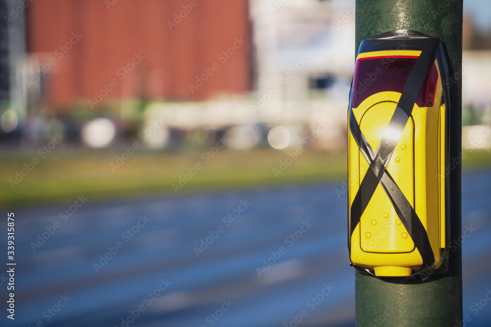Turned off a traffic light button for crossing roadway with blurred bus ...