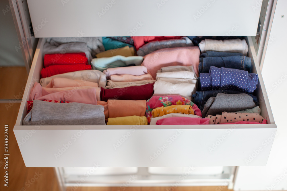 Vertical storage of clothing. children's room. Clothing folded for ...