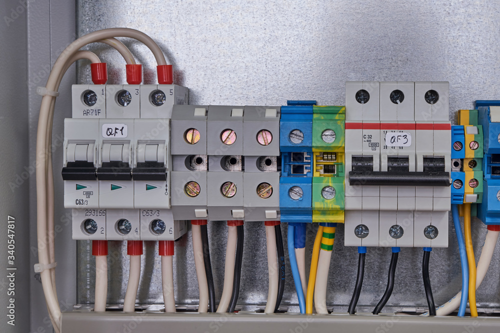 Two modular electrical circuit breakers and terminals with connected ...