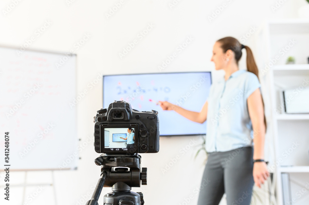 Online studying, online learning. Female teacher is recording classes ...