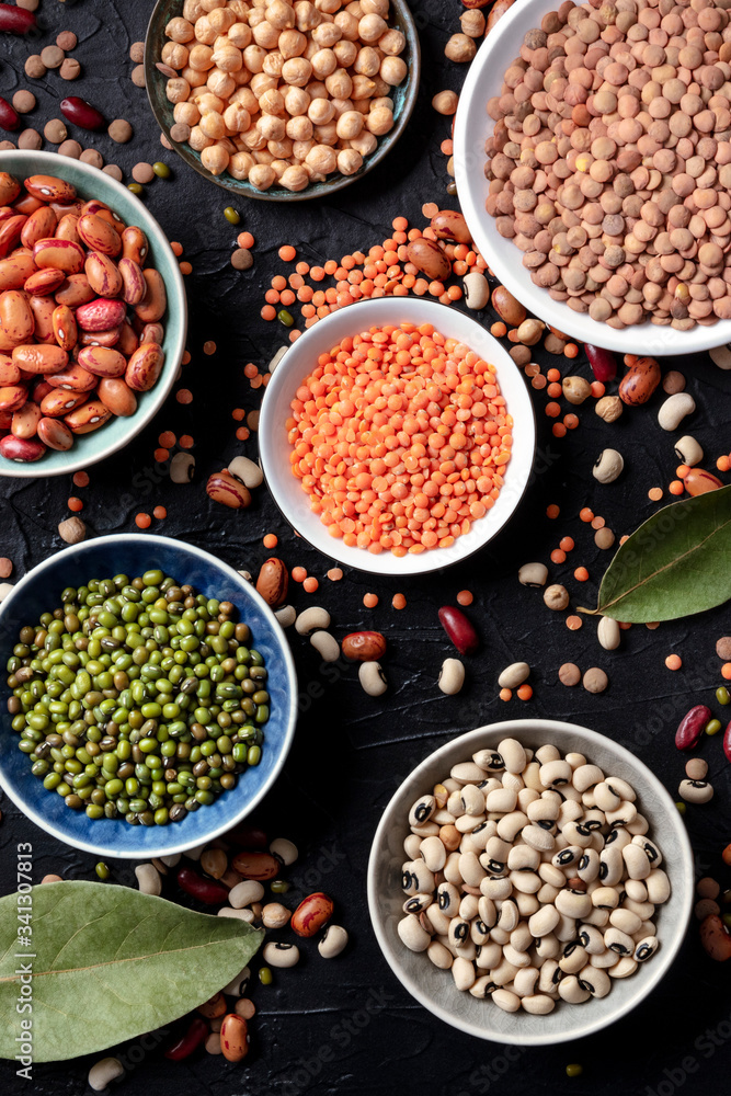Legumes variety, overhead shot on a black background. Lentils, soybeans ...