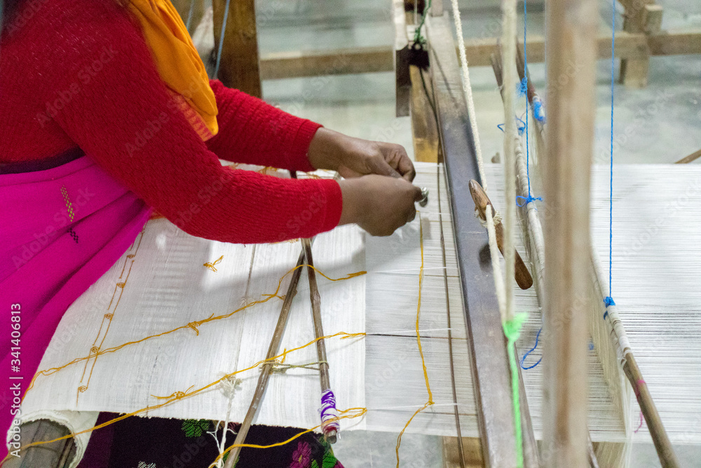 Lady demonstrating weaving of Mekhela (traditional Assamese dress) on ...