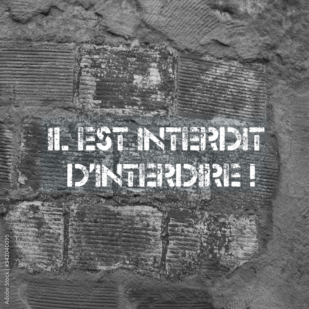 Wall with the French 1968 slogan "il est interdit d'interdire", meaning ...