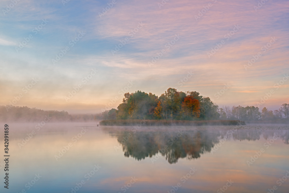 Foggy autumn landscape at dawn of Whitford Lake with mirrored ...