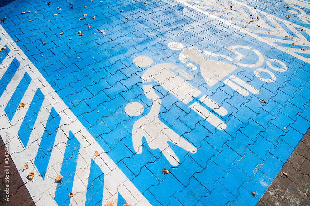 Parking lot reserved only for parents with children. The sign is white ...