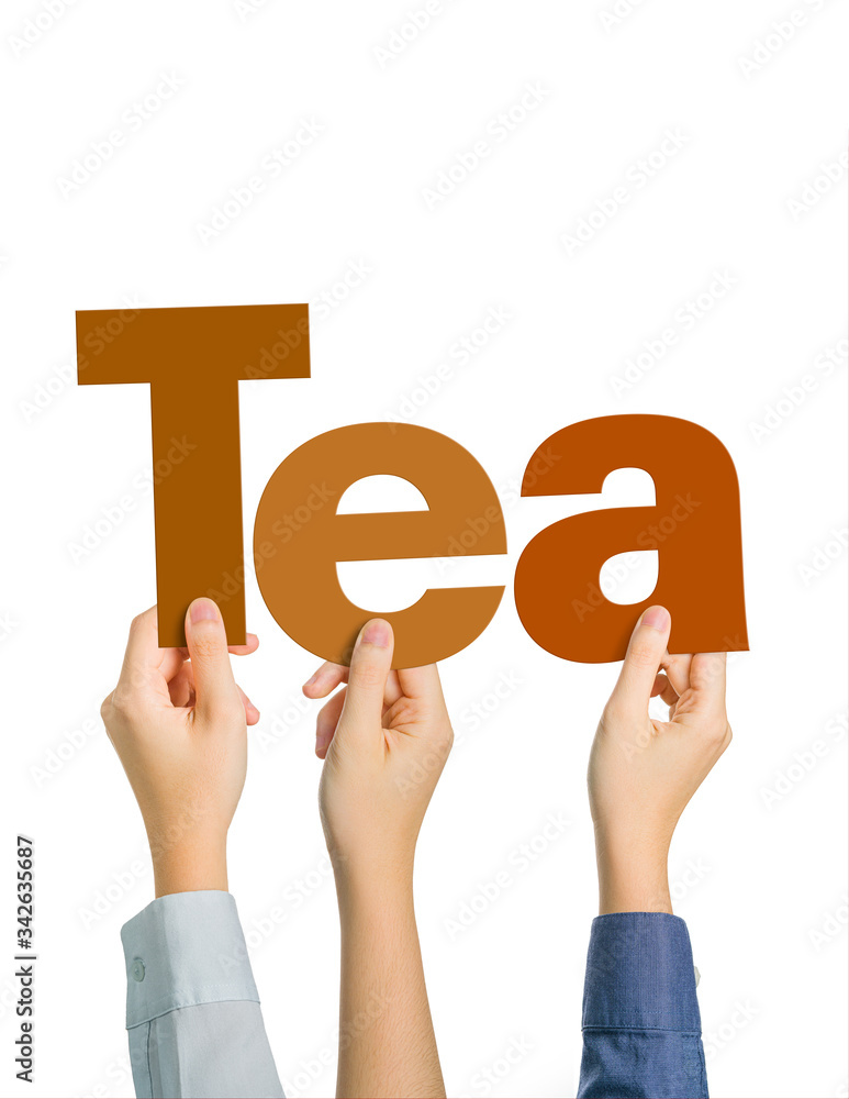 Hands holding English alphabets to form a word TEA on white background ...