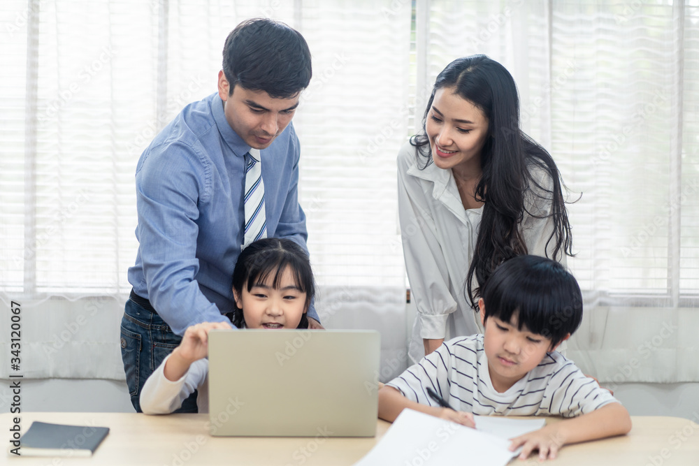 Asian parents teaching homework to children after learning online ...