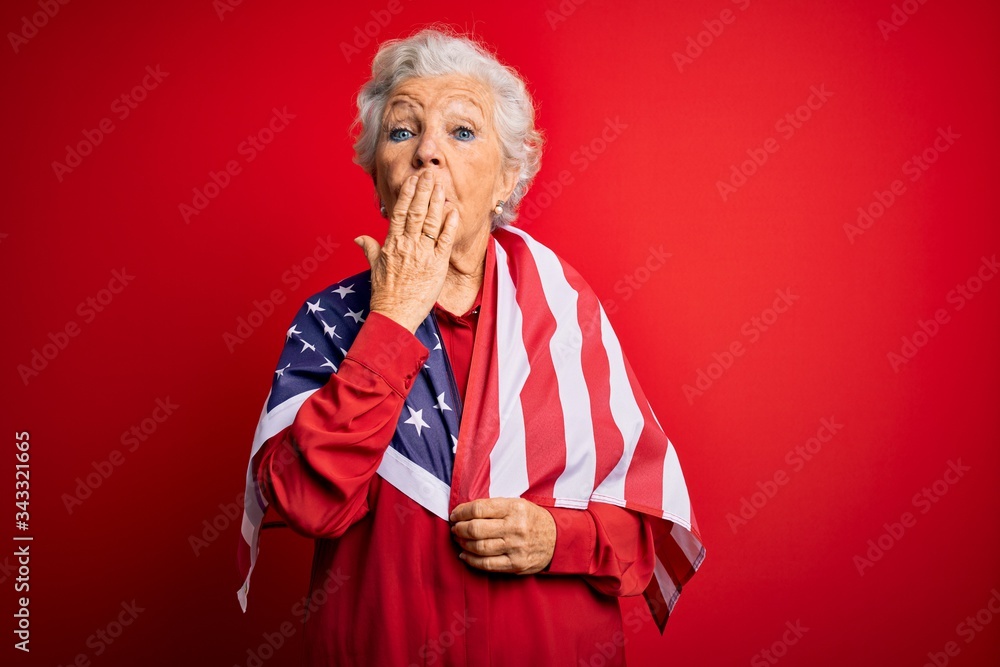 Senior beautiful grey-haired patriotic woman wearing united states flag ...