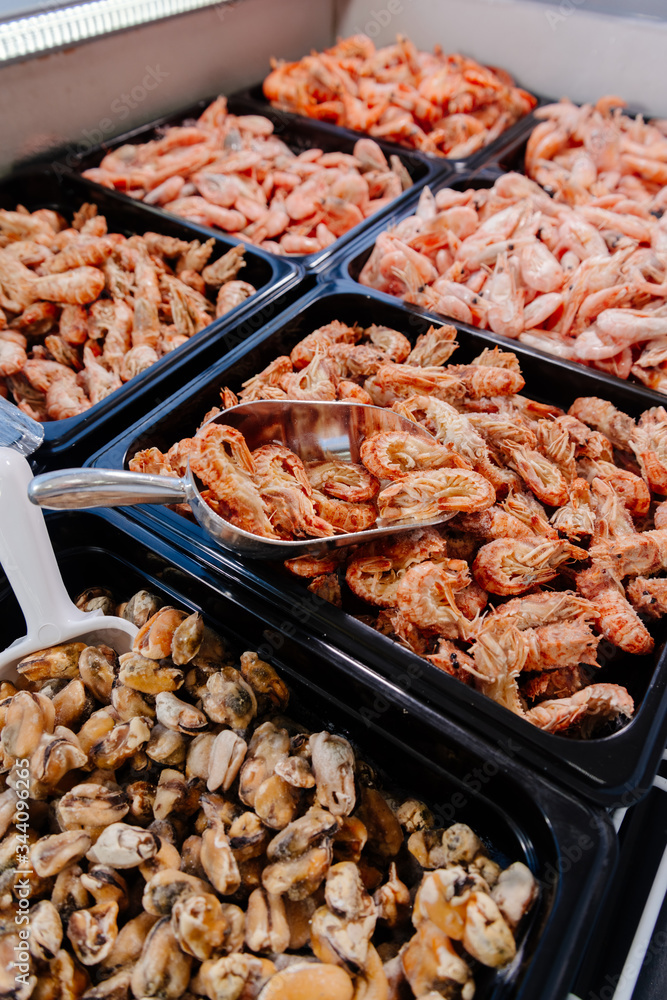 Frozen prawns in a supermarket refrigerated display case. Frozen ...