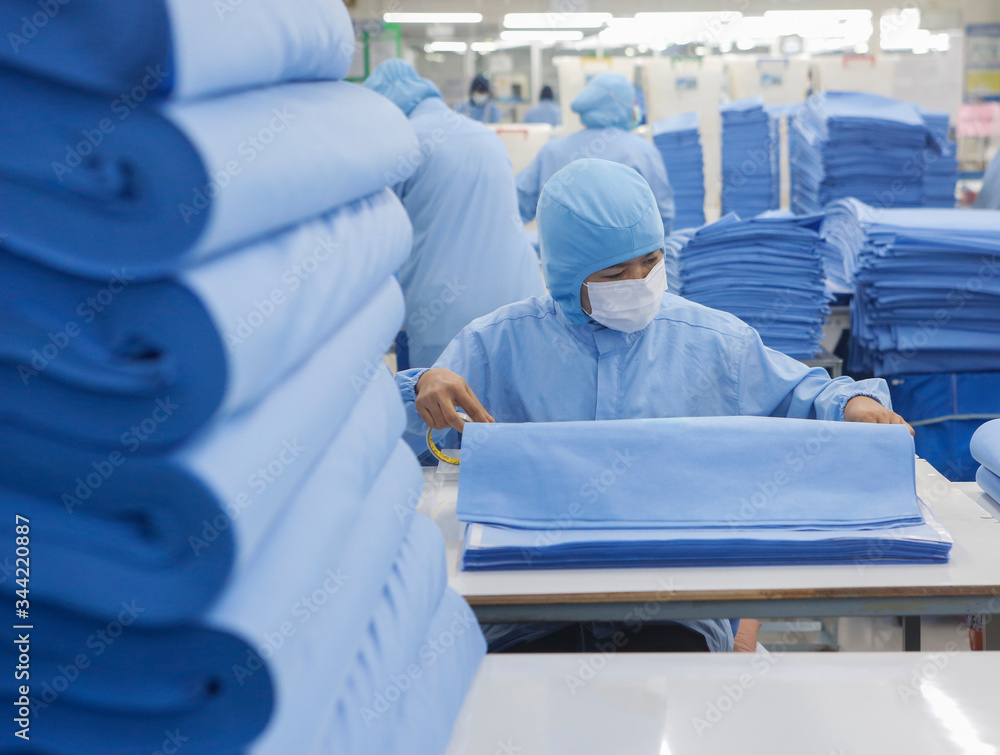 Factory workers are producing Personal Protective Equipment (PPE) for ...