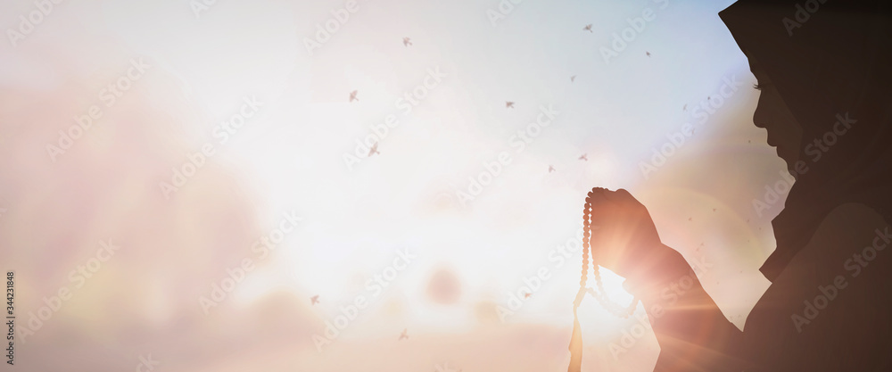 Young muslim woman prayer with hijab pray to God on blur mosque ...