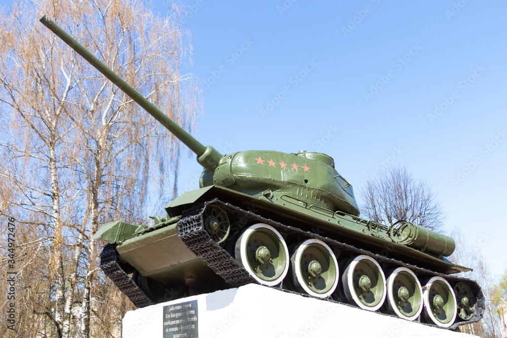 Tank T 34 against the blue sky stands on the podium against the ...