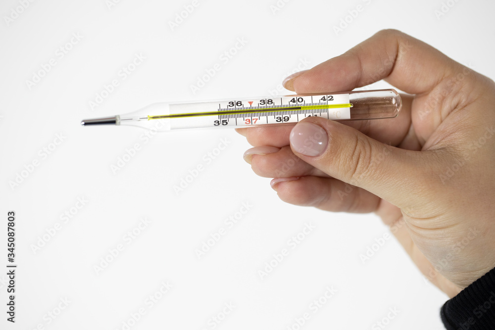 Mercury glass thermometer in female hand which shows extremely high ...