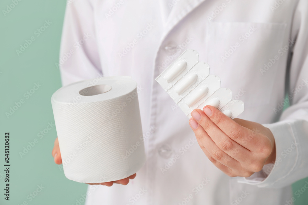 Doctor with toilet paper and hemorrhoidal suppositories, closeup Stock ...