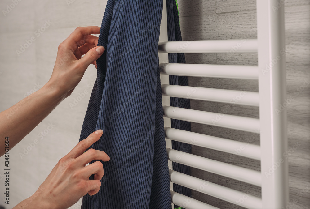 Person using towel for wiping hands dry after washing in bathroom at ...