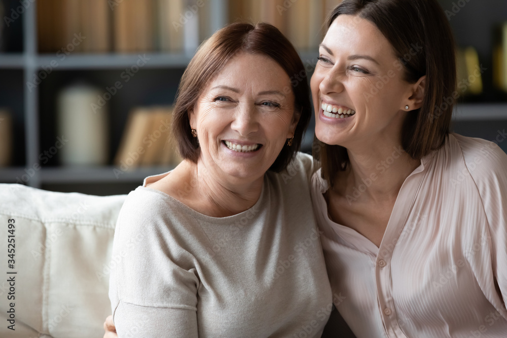 Happy mature mother and adult daughter hugging close up, having fun ...