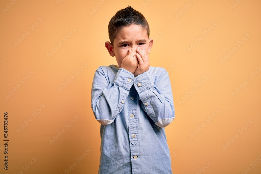 Young little boy kid wearing elegant shirt standing over yellow ...