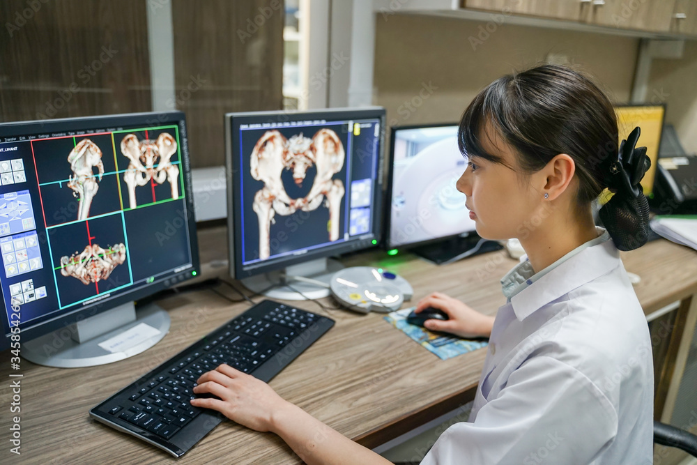 Asian Radiologist interpreting CT image with blur Hip Computed ...