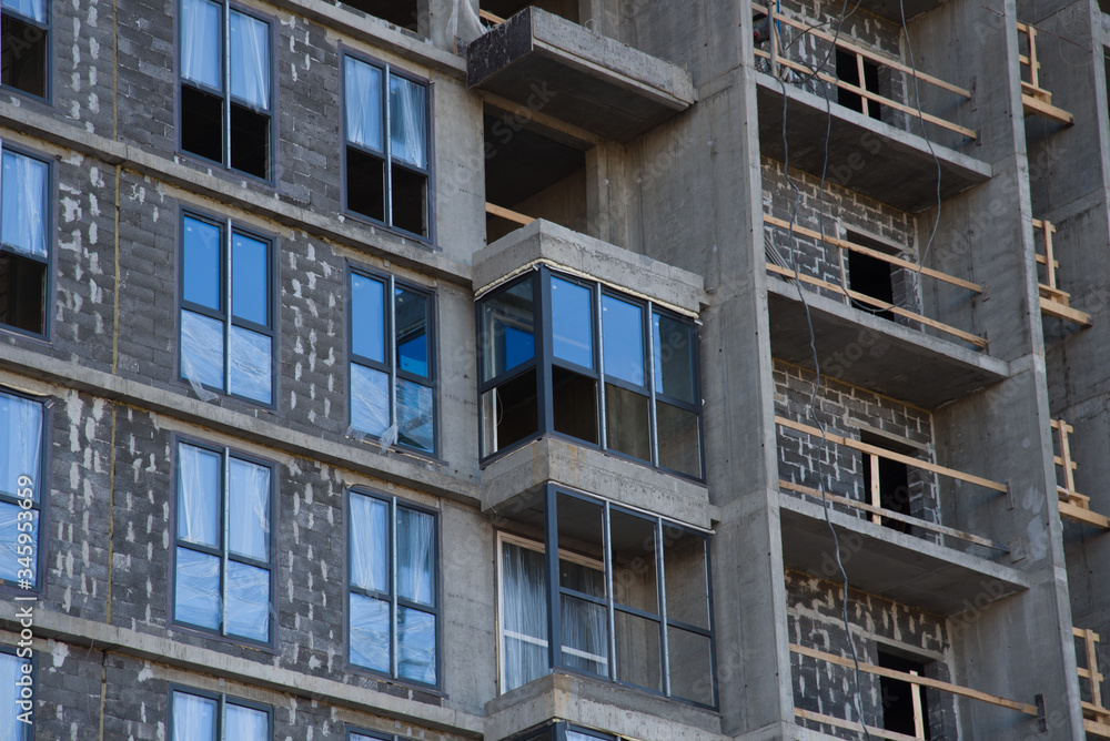 Installation of double-glazed windows in a multi-storey building at a ...