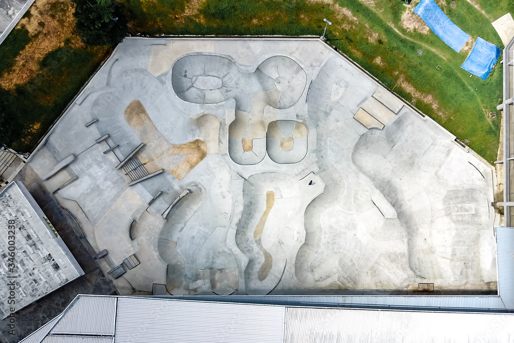 Aerial view of big concrete skate park with lots of pools, ramps and ...