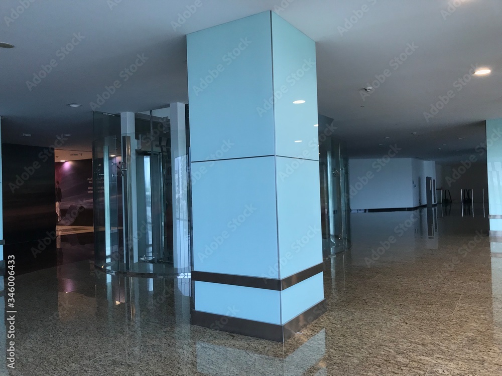 Columns with transparent glass cladding and stainless steel skirting ...