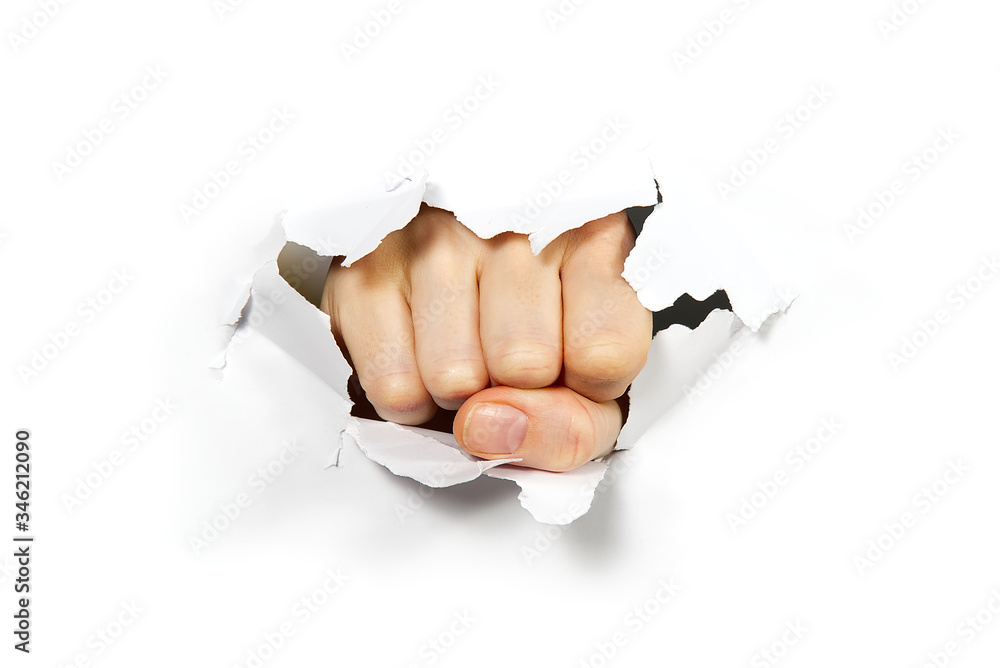 punching hole through paper wall with fist. Punch break through the ...