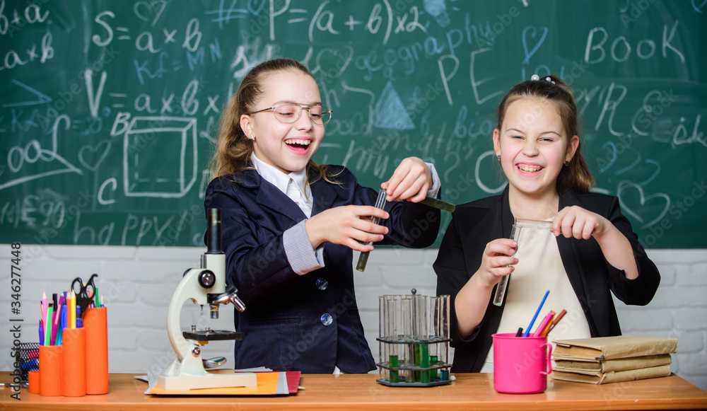 Chemistry research. Biology lesson. Little girls in school lab ...