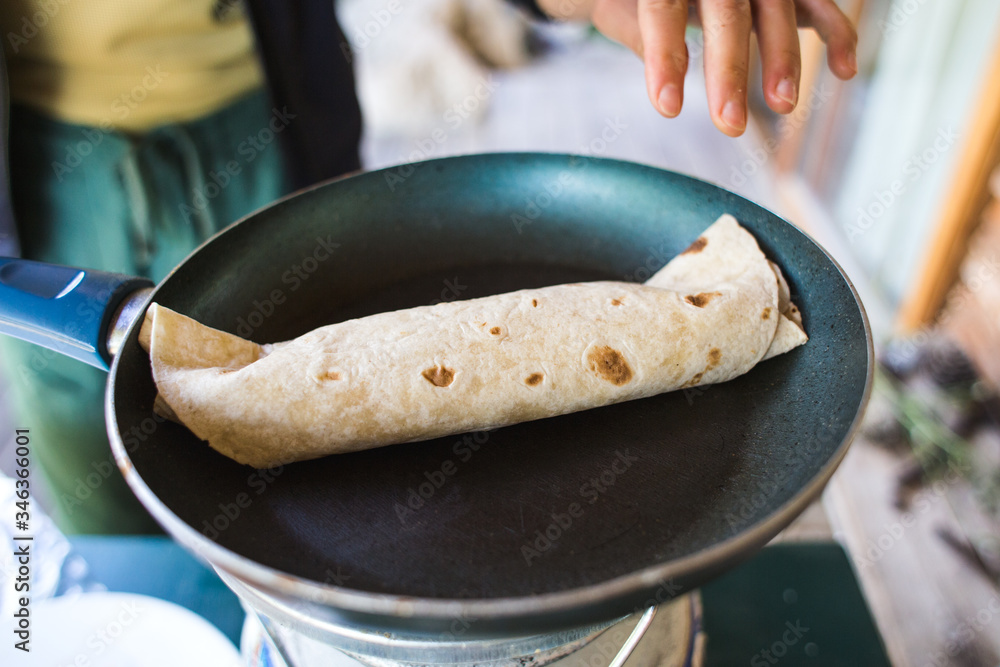 Cooking pita rolls stuffed with vegetables, Pita bread in a pan. Stock ...