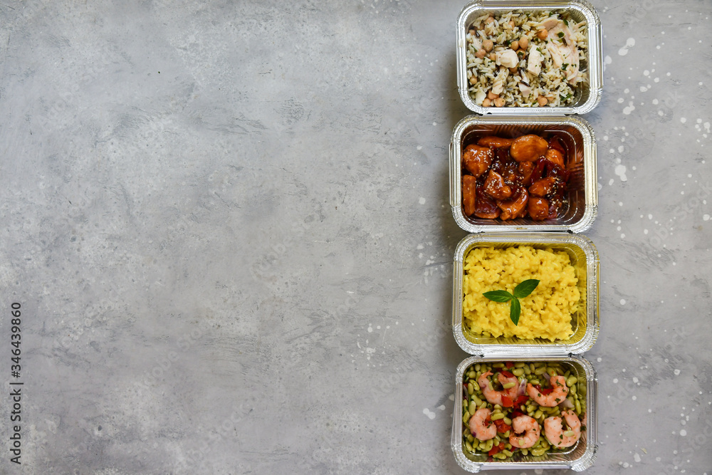 Food delivery. Different aluminium lunch box with healthy food risotto ...