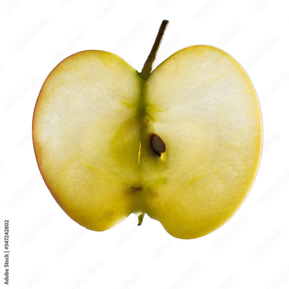 Slice of apple fruit with light shining through backlight showing the ...