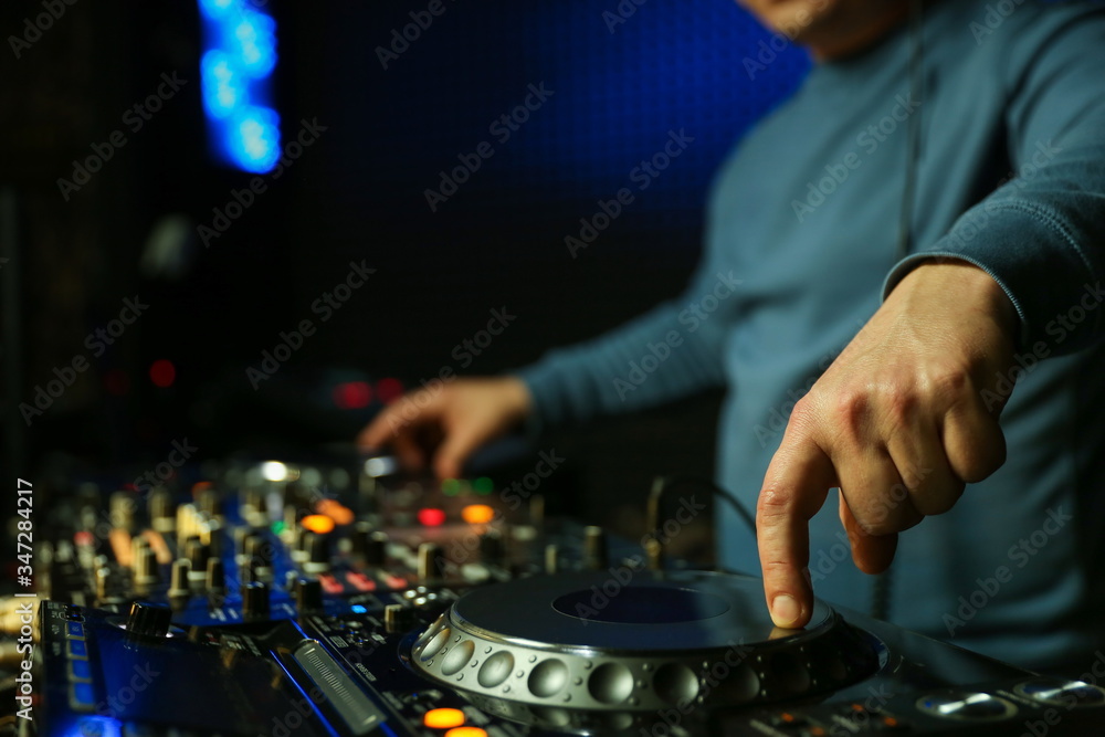 dj hands playing music on turntable close up. dj's hand is mixing ...