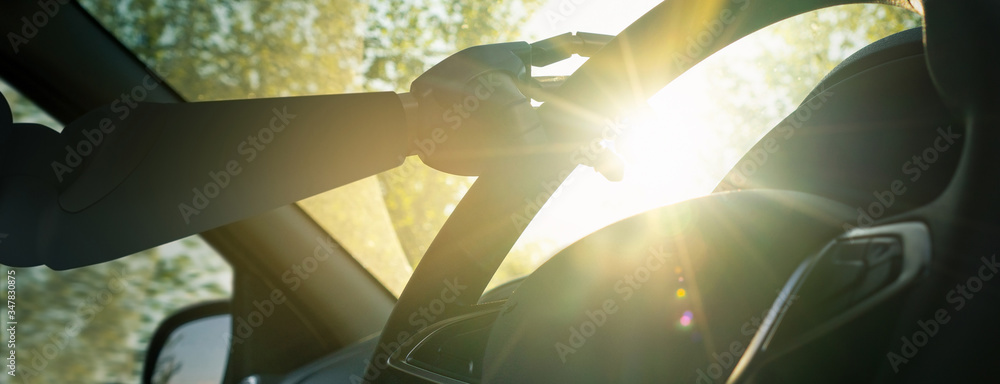 Robot arm on a steering wheel. Artificial intelligence drives a car ...