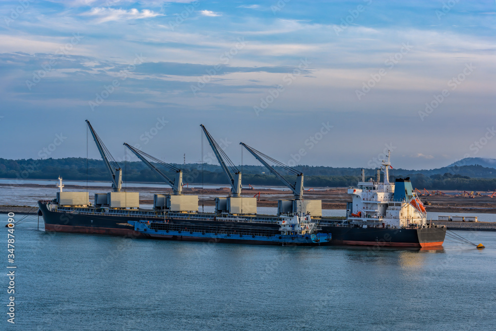 Sand transshipment operations from bulk carrier vessel anchored to ...