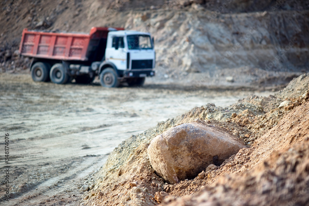 Pile of ore rocks over out of focus background with heavy multi-ton ...