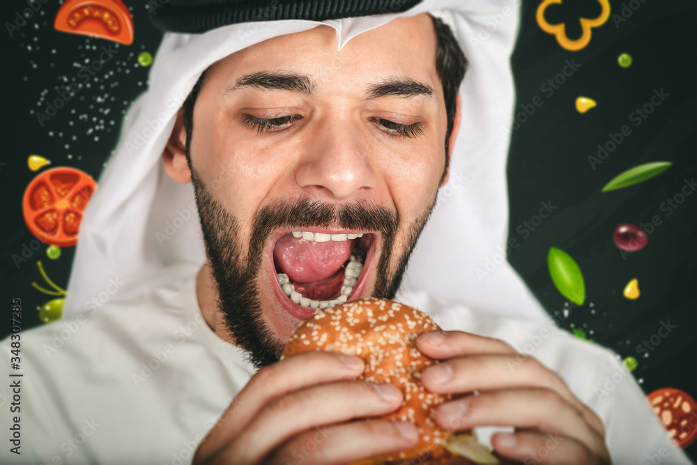 Arab man opened his mouth to eat a big hamburger, a hamburger in his ...