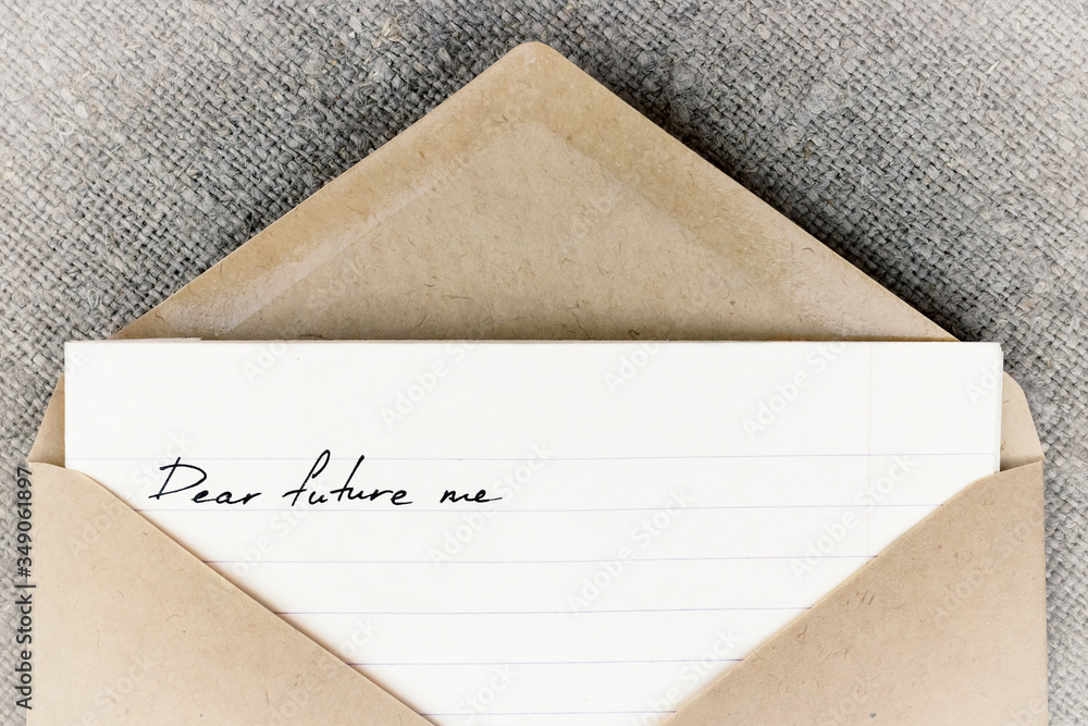 "dear future me" is written on white lined paper, which lies in an open ...