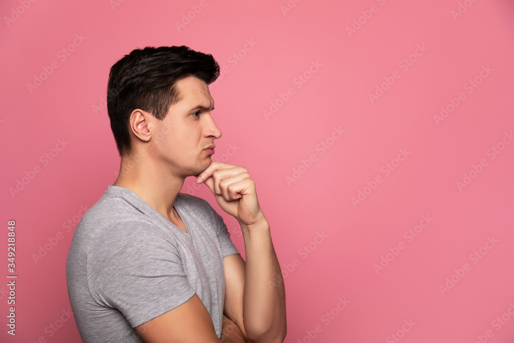 Masculinity. Close-up photo of a handsome man in a grey t-shirt, who is ...