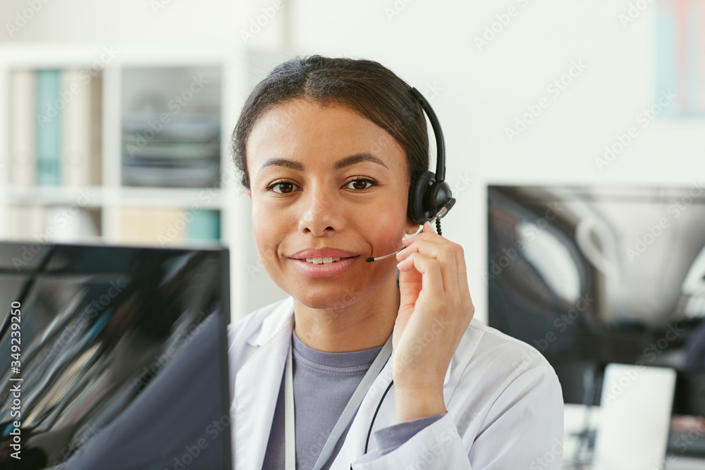 Stock-Foto „Portrait of African young woman in headphone sitting in ...