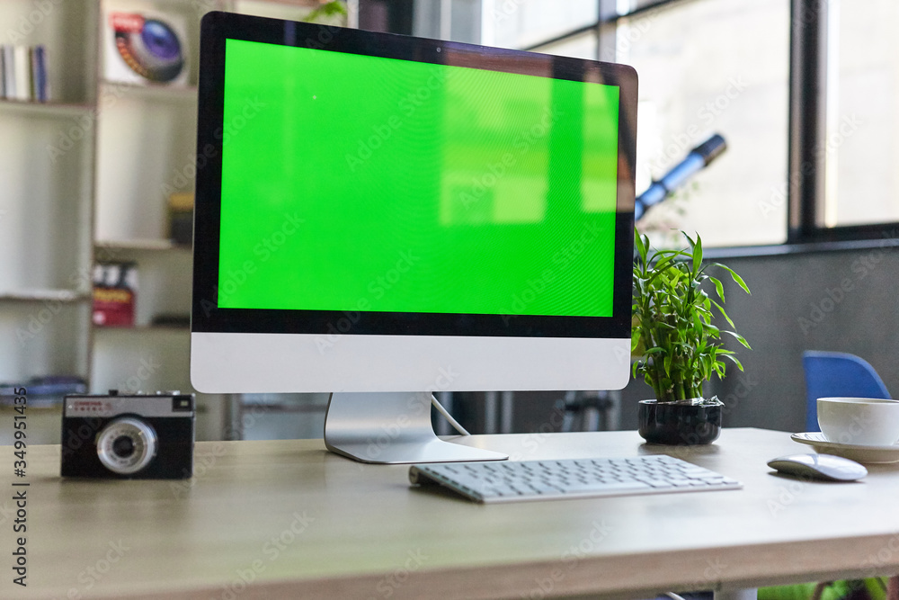 Computer desktop with mock-up green screen white background in office ...