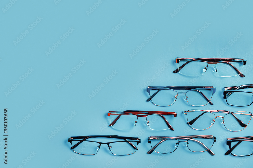 Different types of corrective medical eyeglasses laid down in a heap ...