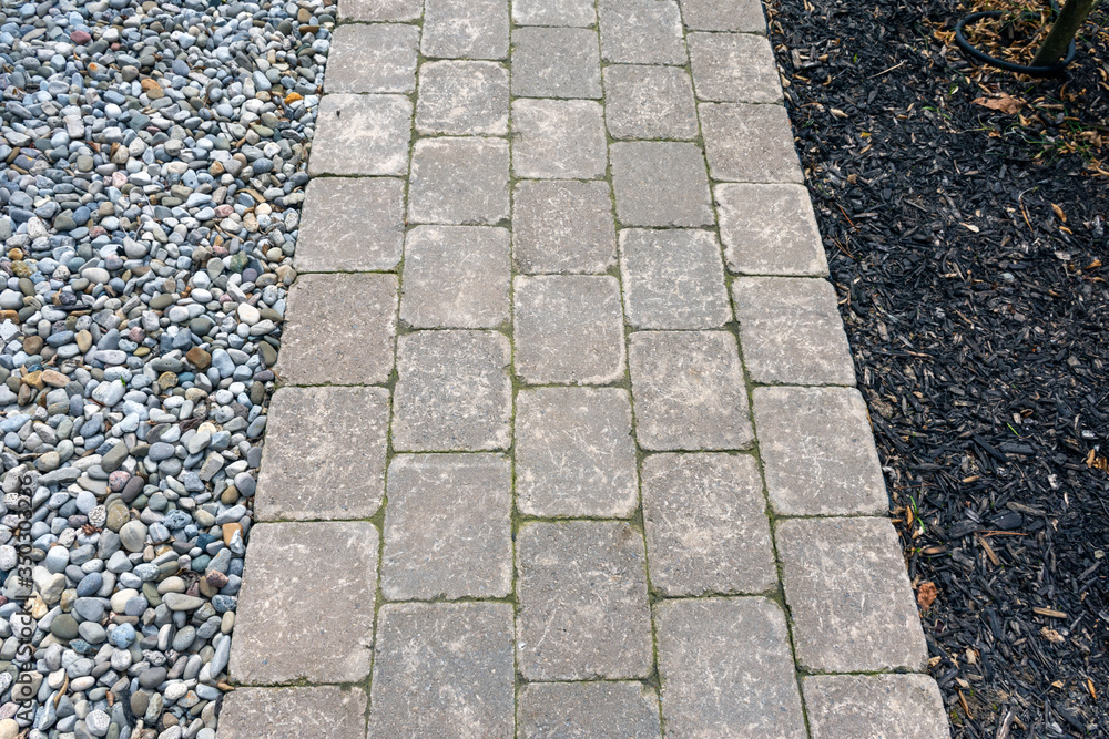 Tumbled paver walkway with wood chip and pea gravel mulches create a ...
