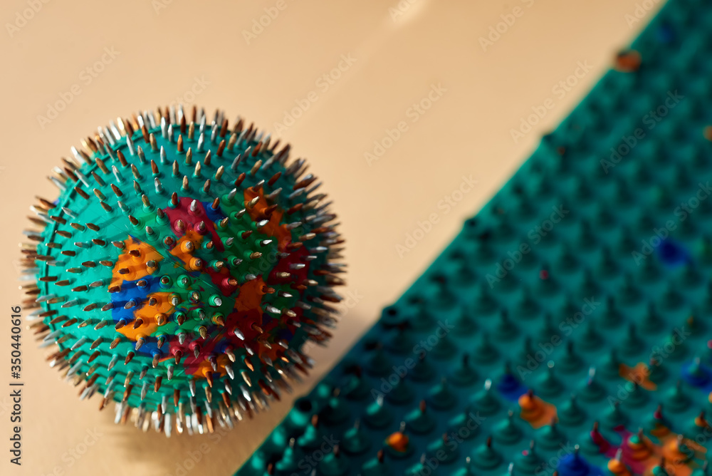 Composite frame with massage mat with metal spikes and ball of green ...