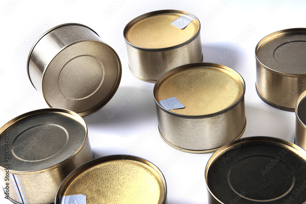 Closed golden metal tin cans on white background. Bunch of aluminum ...