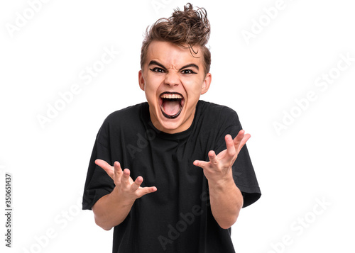 Rebellious teen boy dressed in black, isolated on white background ...
