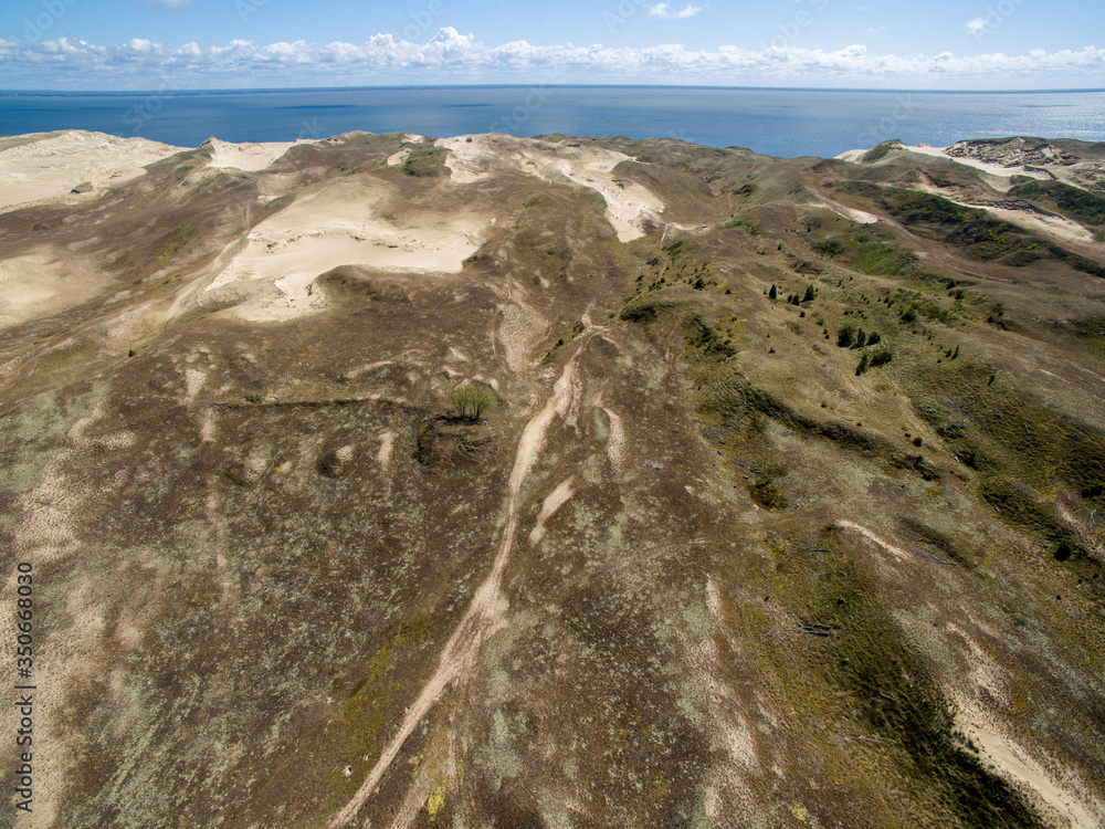 Aerial view with dunes, forest and sea in Curonian spit on a sunny day ...