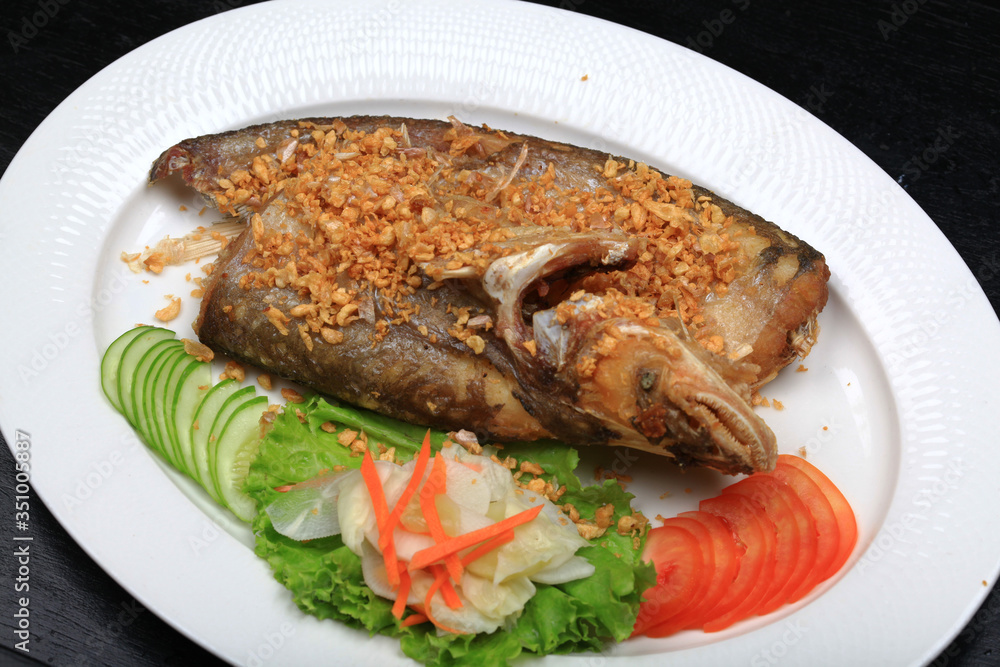 Ompok bimaculatus Fish Fried with crispy garlic Stock Photo | Adobe Stock