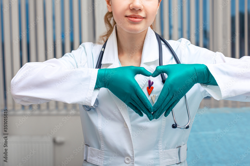 The doctor hands shows the heart, a symbol of health. Copy space ...