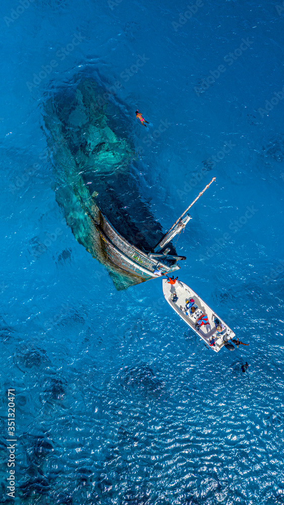 Aerial view of a ship wreck and a boat near Keyodhoo, Vaavu Atoll ...