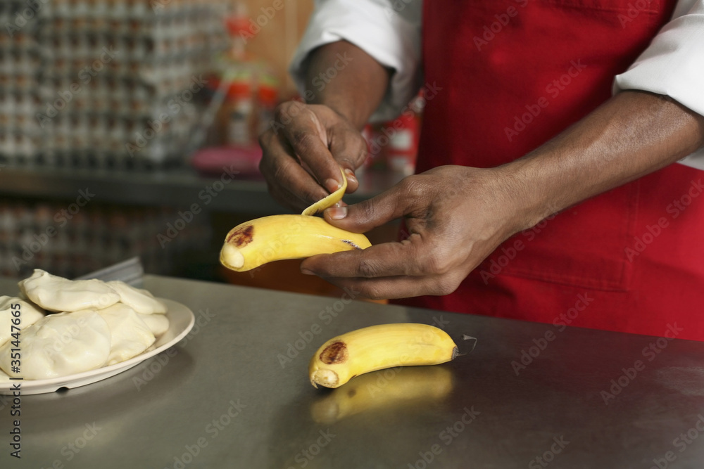 Man peeling banana for roti pisang Stock Photo | Adobe Stock