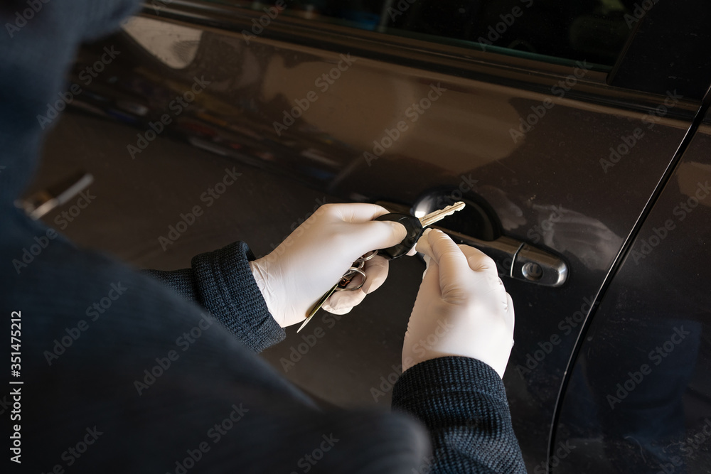 Man driver wearing protective white gloves and cleaning car keys with ...